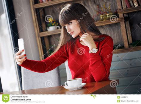 Girl Reading Sms On Mobile Phone Sitting In Cafe Stock Image Image Of