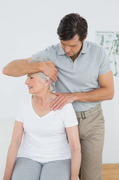 Premium Photo Senior Woman Getting The Neck Adjustment Done
