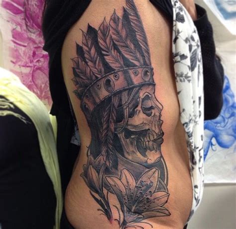 Black And Grey Shade Rib Piece Female Skull Tattoo Wearing Headdress