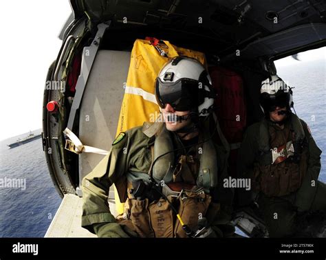 Us Navy Sailors Look On From The Cabin Of An Mh 60s Sea Hawk Helicopter