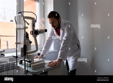 Doctor Examining Eye Scanner Machine At Clinic Stock Photo Alamy