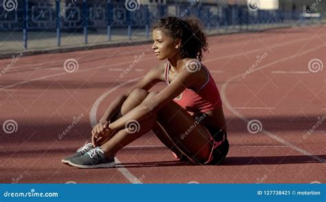 Cute Athletic Girl Tired After Workout At Stadium Sitting On Track