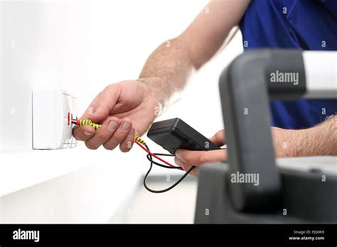 Electrician Installing Internet Installation Of The Wall Socket Man Mounts In A Wall