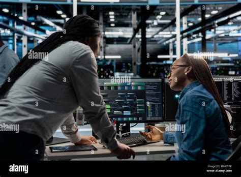 Data Center Manager Supervising Work Done By Engineer Using Artificial Intelligence Neural