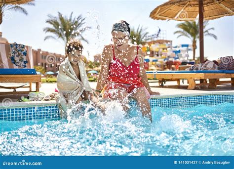 Old Lady With Her Grandson Having Fun Near Pool On Resort Stock Image