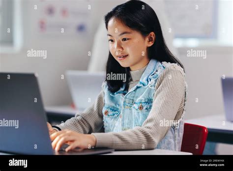 Asian Kid Nurturing Her Newly Discovered Tech Talent As She Learns To