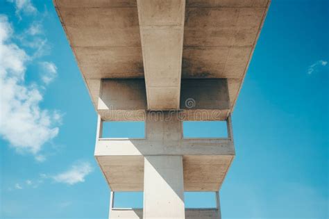 Concrete Structure With Blue Sky In The Background And White Cloud In The Sky Generative Ai