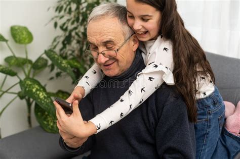 Teenage Girl Taking Photo With Mobile Phone Of Herself And Her