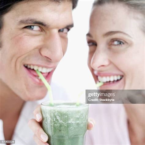 69 Close Up Of A Young Couple Drinking From A Glass Using Drinking