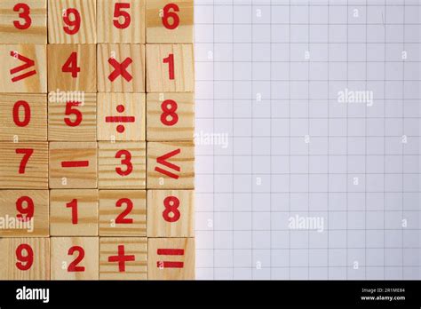 Wooden Cubes With Mathematical Symbols And Numbers On Sheet Of Grid