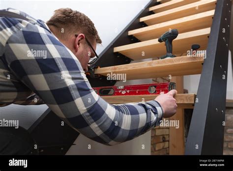 Home Improvement Handyman Building Staircase In A Natural Light Stock