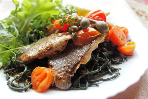 Pan Fried Sea Bass Fillets In A Pastis And Caper Butter Sauce Served With