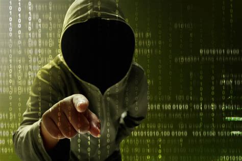 130 Hooded Computer Hacker In The Shadow With Binary Codes Stock