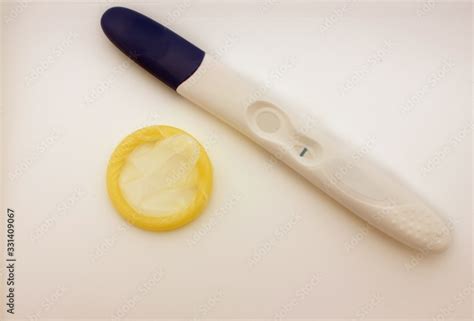 Negative Pregnancy Test With Condom On A White Background Protection Against Unwanted