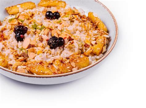 Premium Photo Muesli With Dried Fruits And Milk In Ceramic Bowl