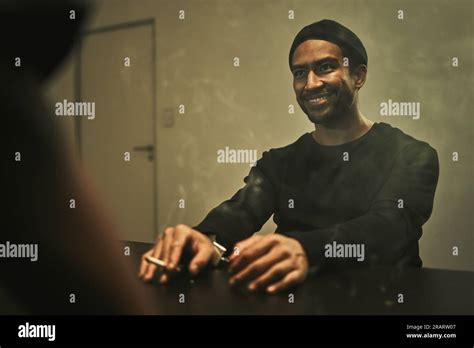 Man Suspect Smoking And Detective In Interrogation Room With Criminal