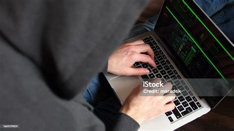 Anonymous Hooded Hacker Programming In Computer Console Breaking