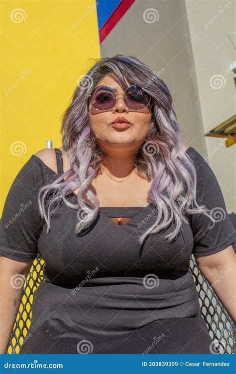 Beautiful Chubby Girl In A Black Dress On A Dark Background Stock