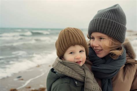 A Little Boy And His Mom Spending Windy Winter Day At The Local Beach