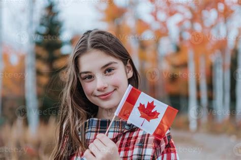 Cute Girl With Canadian Flags In Her Hands On Nature Landscape