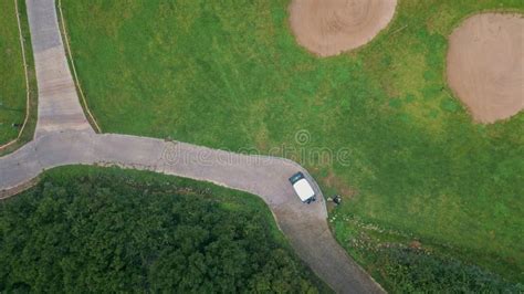 Aerial Golf Cart Standing On Winding Path Of Lush Green Fairway Golf