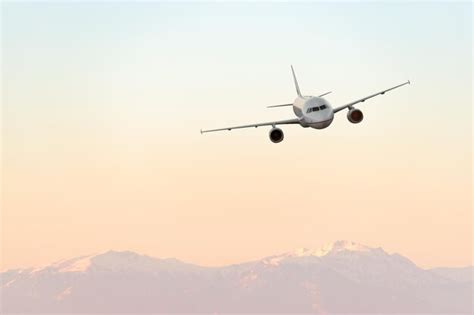 Premium Photo Airplane Flying Over The Sea And Mountains
