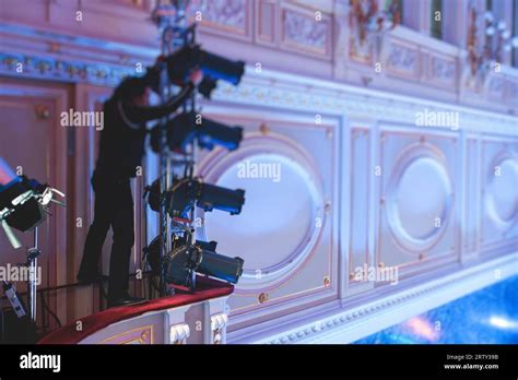 Stage Worker Assistant Sets Up Lights Light Engineer Lighting Technician Adjusting Lights For
