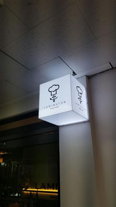 A White Box Hanging From The Ceiling In A Restaurant
