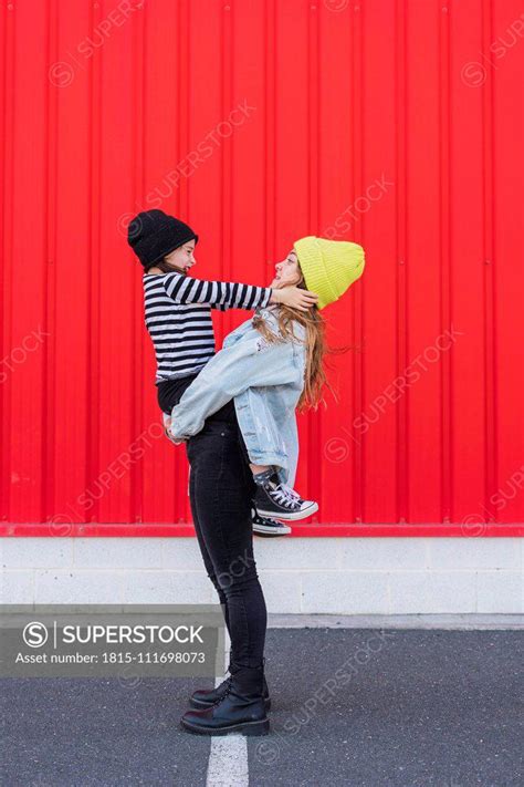 Teenage Girl And Younger Sister Having Fun Together Superstock