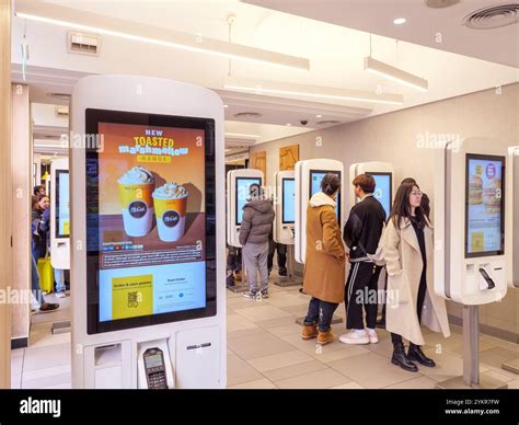 People Ordering Their Food Using Touchscreen Order Terminals Inside A Mcdonalds Restaurant Uk