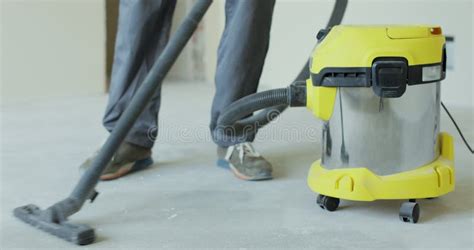 Man Vacuums The Floor With An Industrial Vacuum Cleaner Preparing The