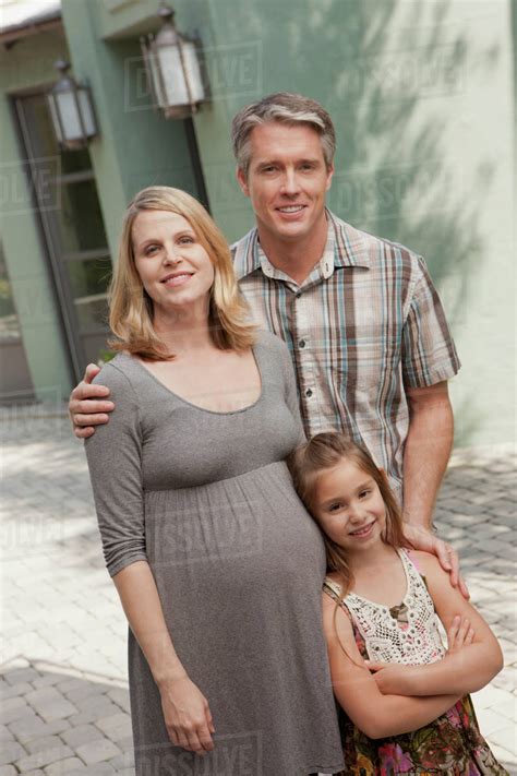 Pregnant Mother Father And Daughter 6 7 Posing For Portrait Stock