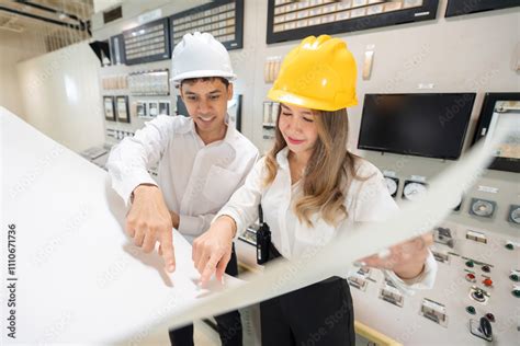 Male And Female Engineers Look At Blueprints Analyzing The Structure Of Wind And Water Power