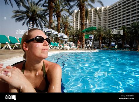 A Woman Sunbathing In A Pool At A Hotel Resort Dead Sea Israel Stock