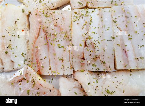 Background Made Of Cod Fish Fillet Cut Into Squares And Sprinkled With