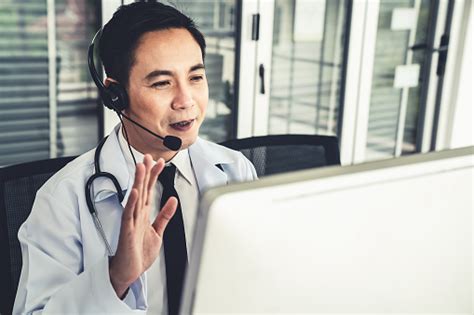 헤드셋을 착용한 의사가 클리닉이나 병원에서 화상 통화로 활발하게 이야기하고 있습니다 원격 의료 및 원격 의료 서비스의 개념