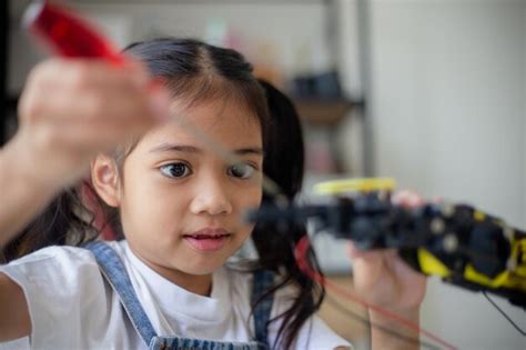 Premium Photo Stem Education Concept Asian Young Girl Learning Robot