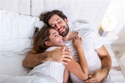 Beautiful Loving Couple Kissing In Bed Beautiful Young Couple Lying