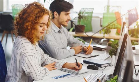 Man And Woman Working On Computer At Desk Stock Image Image Of
