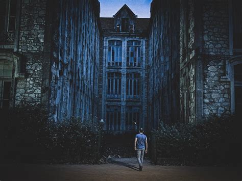 Premium Photo Rear View Of Man Walking Towards Building
