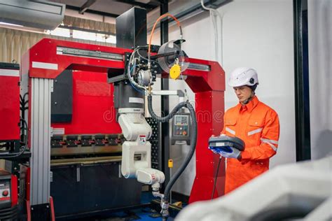Engineers Mechanic Using Computer Controller Robotic Arm For Welding