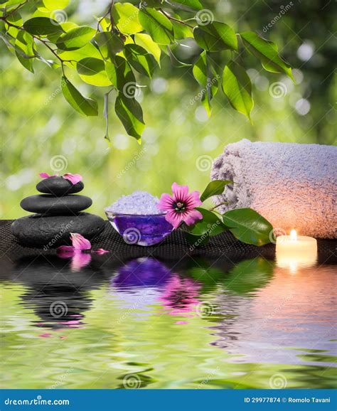 Two Candles And Towels Black Stones And Purple Flower On Water Stock