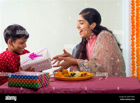 Brother Giving T To His Sister On The Occasion Of Raksha Bandhan