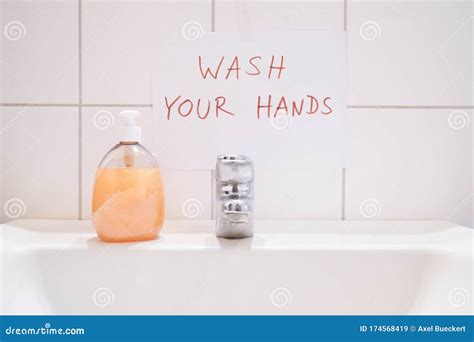 Wash Your Hands Handwritten Notice Above Bathroom Sink Stock Image