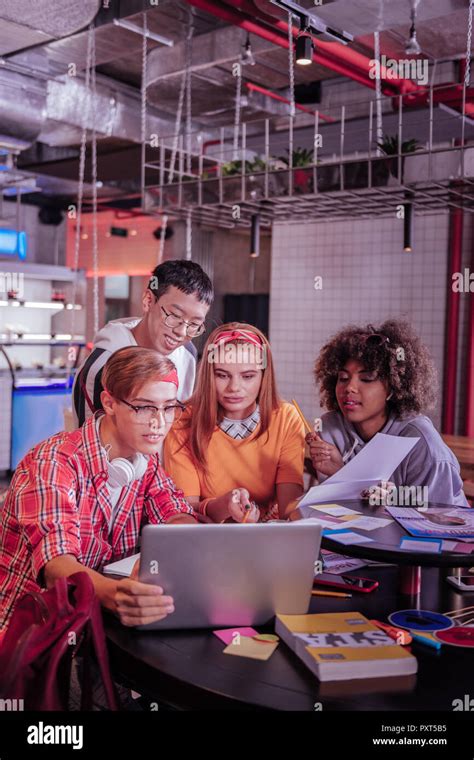 Concentrated Classmates Completing Task Together After Lessons Stock