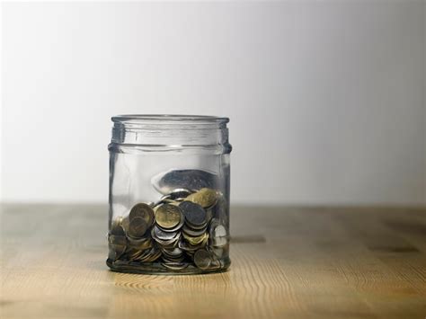 Premium Photo Saving Jar On The Wooden Background