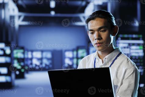 Skilled Programmer In Data Center Uses Laptop To Prevent System Overload During Peak Traffic