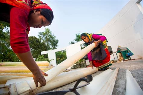 Premium Photo Two Women Workers Are Removing The Bark From The Trunk Of A Banana Tree To Make