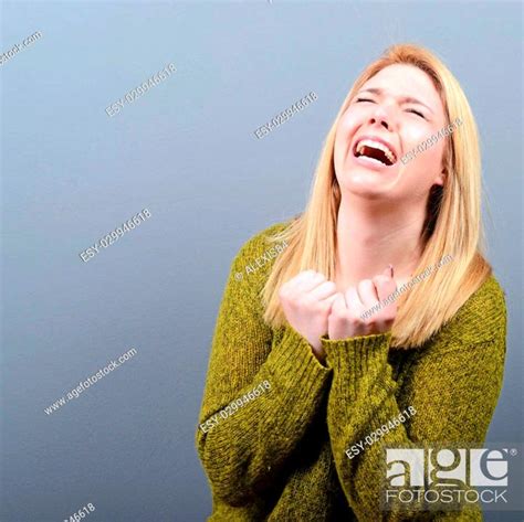 Woman Praying About Something Or Begging For Mercy Against Gray