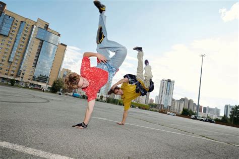 Breakdancers Performing Handstands In Urban Environment Stock Image